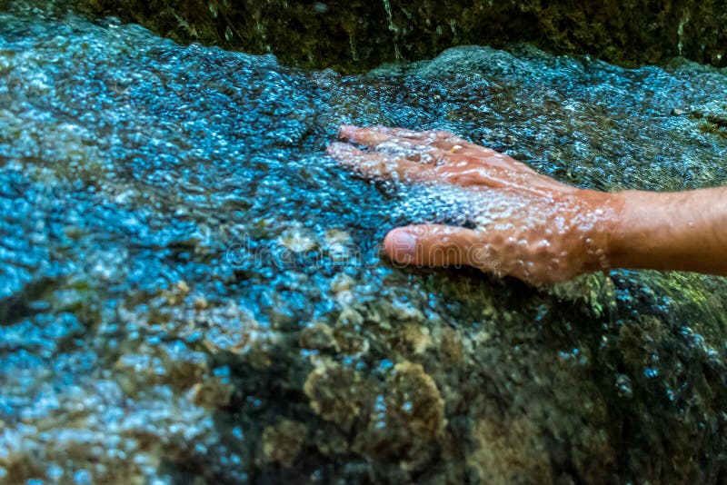 Man Hand on Stone Falling Water Stock Photo - Image of colorless ...