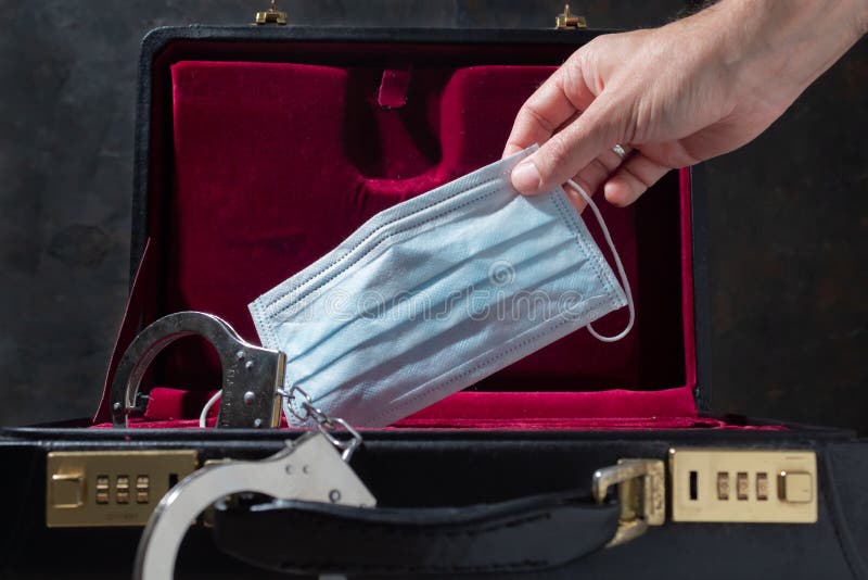 Caucasian Man Hand Stuffing Face Mask into Security Briefcase with ...