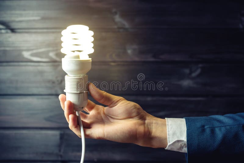 Hand Holds a Glowing Light Bulb. Creative Idea in Business Stock Photo ...