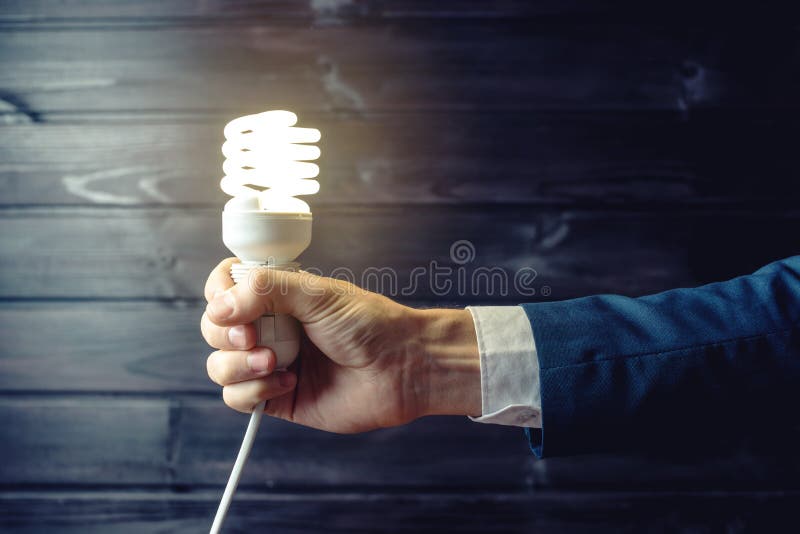 Hand Holds a Glowing Light Bulb. Creative Idea in Business Stock Photo ...