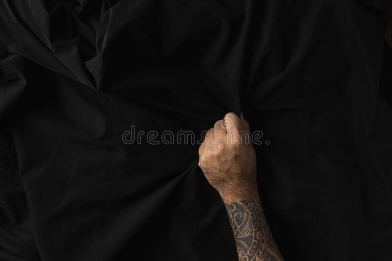 Man Hand with Tattoos Holding Wrinkle Black Fabric Texture Stock Photo ...
