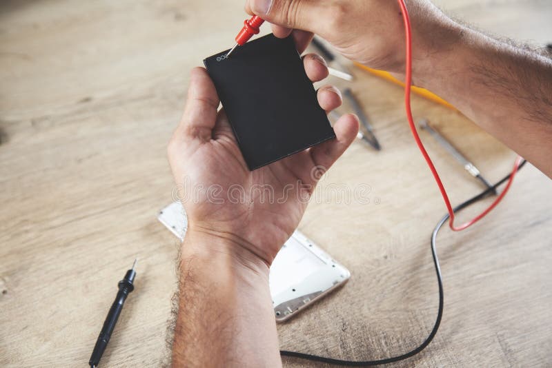 Man hand tester and phone stock image. Image of repair - 157516669