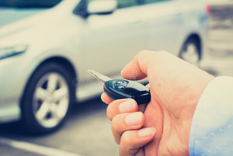 A Man Hand about To Press Button of Remote Control Car Key Stock Image ...