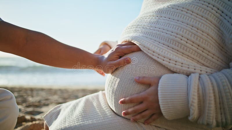 Man Hand Touching Pregnant Belly Wife Beach Vertically Closeup Future