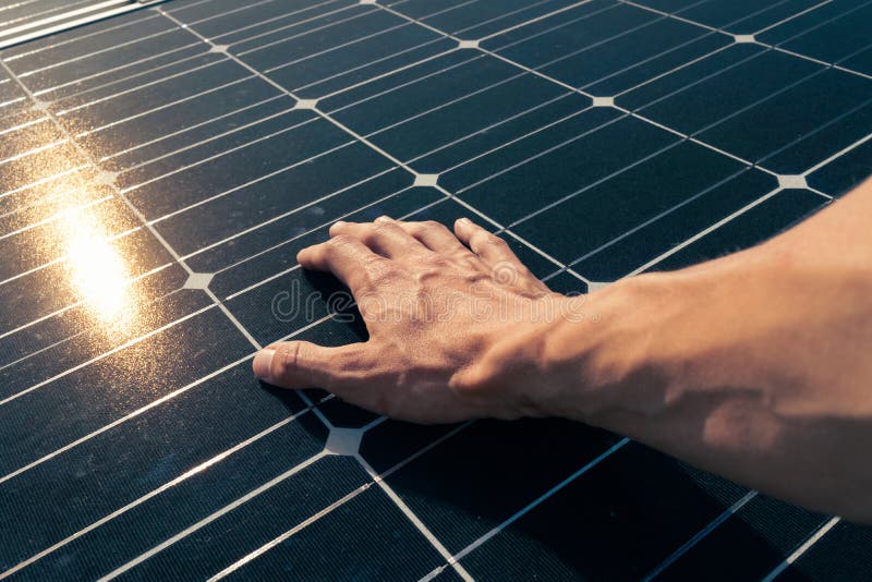 Hand and solar panel stock photo. Image of green, blue - 223191310