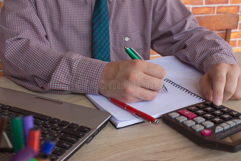 Man Hand Using Calculator and Writing Make Note with Calculate about ...