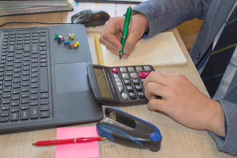 Man Hand Using Calculator and Writing Make Note with Calculate about ...