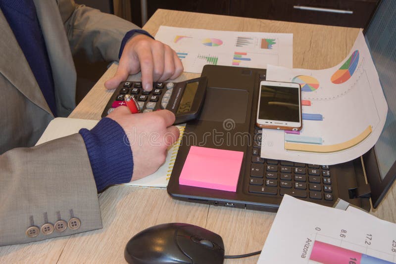 Man Hand Using Calculator and Writing Make Note with Calculate about ...