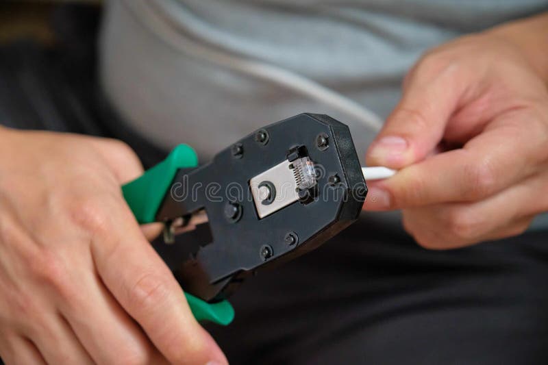 Man Hands Attaching Net Cable To RJ45 Connector Using Data Cable ...