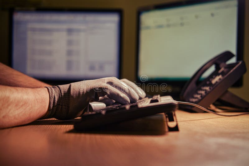 Man Hands in Dark Gloves Typing on a Computer Keyboard Against the ...