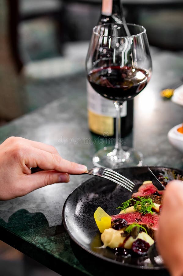 Man Hands Eats Meat in a Restaurant Stock Photo - Image of male, hungry ...