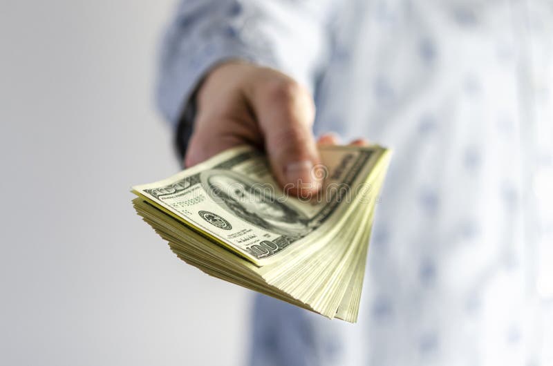 A Man Hands Over a Thick Wad of Dollars. Bribe Stock Image - Image of ...