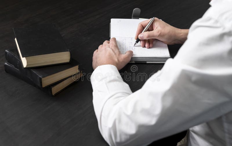 Man Hands Taking Notes in Planner. Books or Codes at Table for Study ...