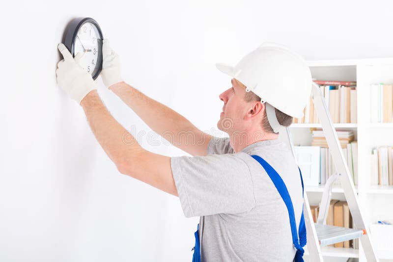 Man hanging clock stock image. Image of builder, household - 51883337