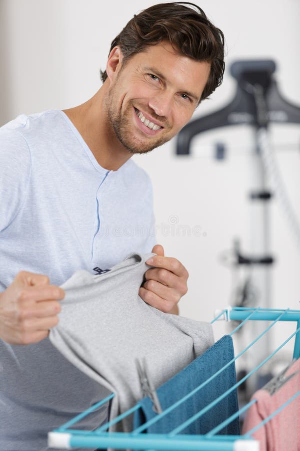 Man Hanging Clothes on Indoor Laundry Line Stock Image - Image of ...
