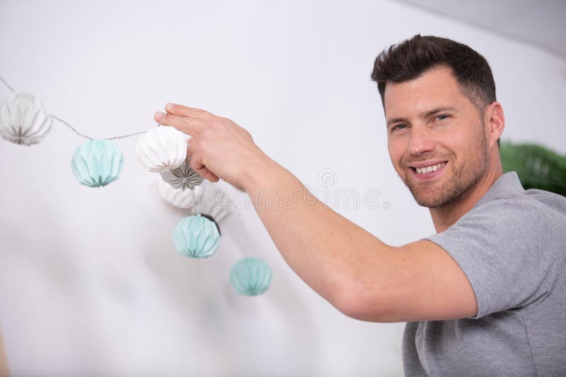Man Hanging Decorative Paper Garland Stock Photo - Image of leisure ...