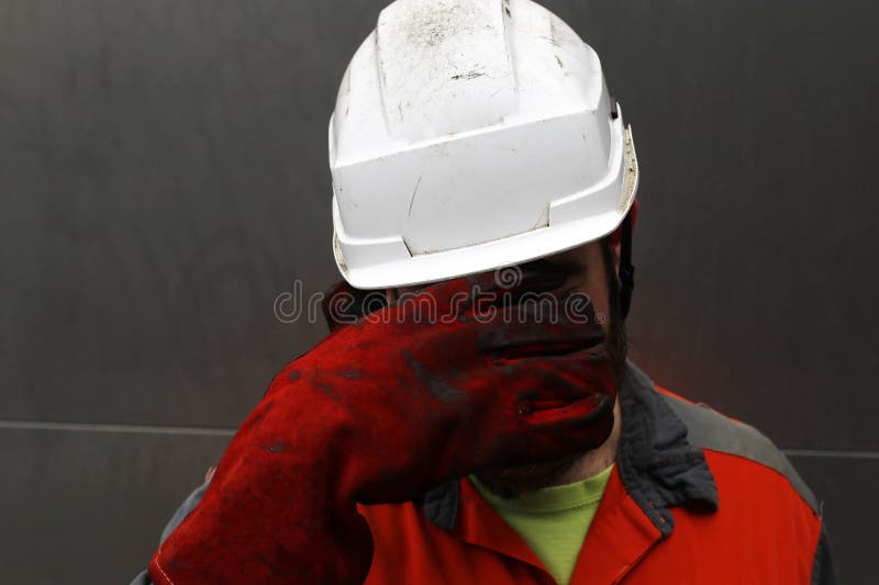 Man in a Hard Hat Shielding His Face with His Hand Stock Image - Image ...