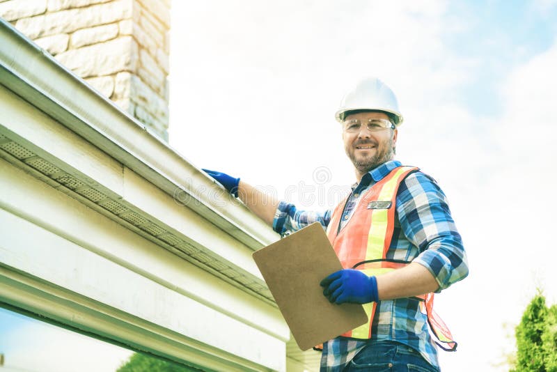 Man with Hard Hat Standing on Steps Inspecting House Roof Stock Image ...