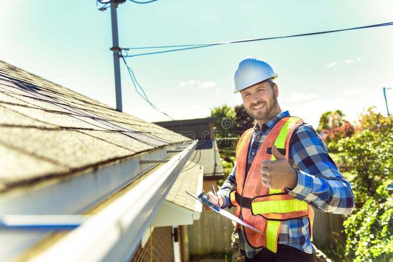 Man with Hard Hat Standing on Steps Inspecting House Roof Stock Photo ...