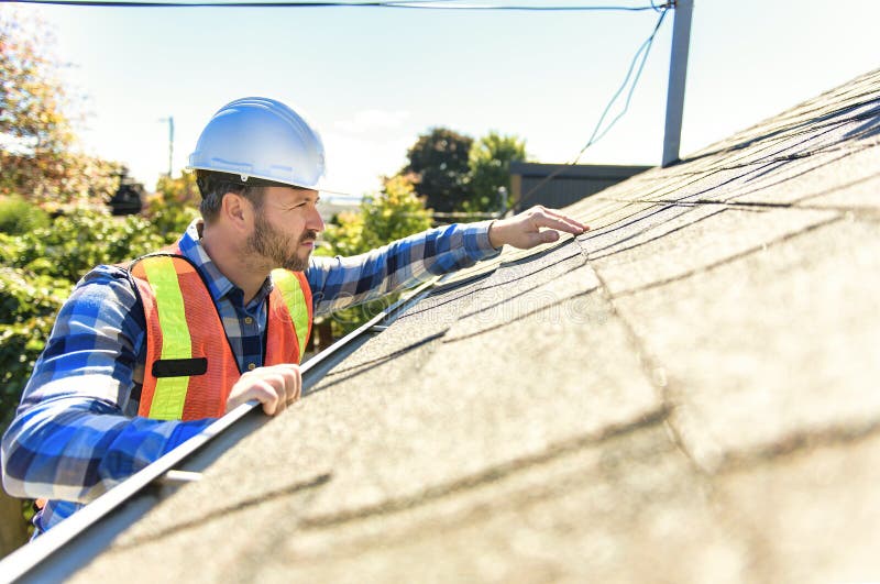 Man with Hard Hat Standing on Steps Inspecting House Roof Stock Photo ...
