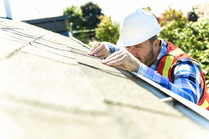 Man with Hard Hat Standing on Steps Inspecting House Roof Stock Photo ...