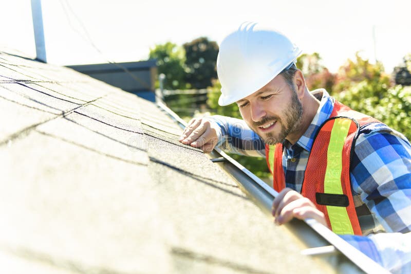 Man with Hard Hat Standing on Steps Inspecting House Roof Stock Photo ...
