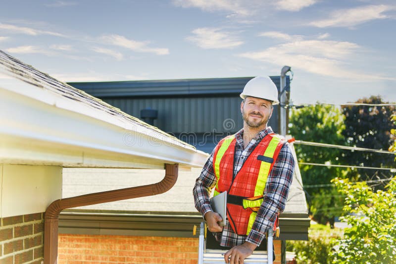 Man with Hard Hat Standing on Steps Inspecting House Roof Stock Photo ...