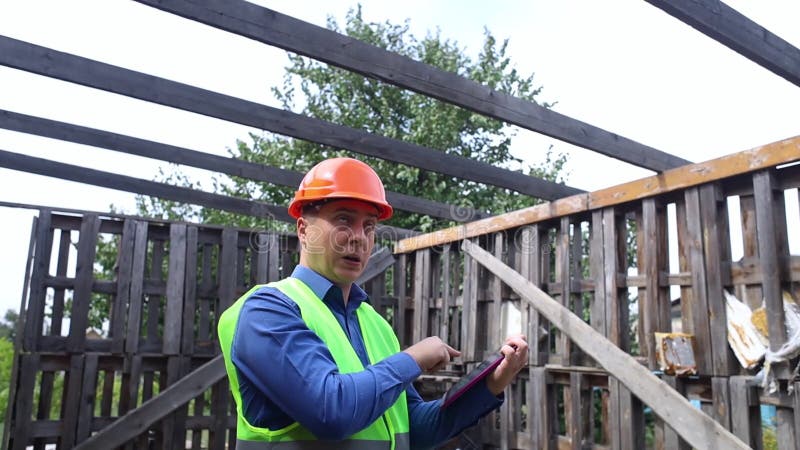 Building Inspector. Man in a Hard Hat and a Yellow Reflective Vest ...
