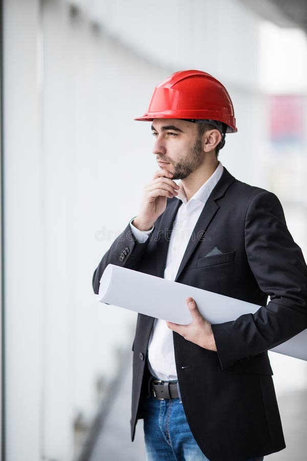 Man in Hard Hats at Building with Plans Thinking Stock Photo - Image of ...