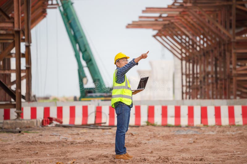 Man in Hardhat with Laptop at the Infrastructure Construction Site ...