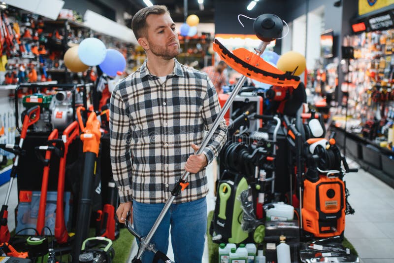 A Man in a Hardware Store Choosing a Tool Stock Image - Image of ...