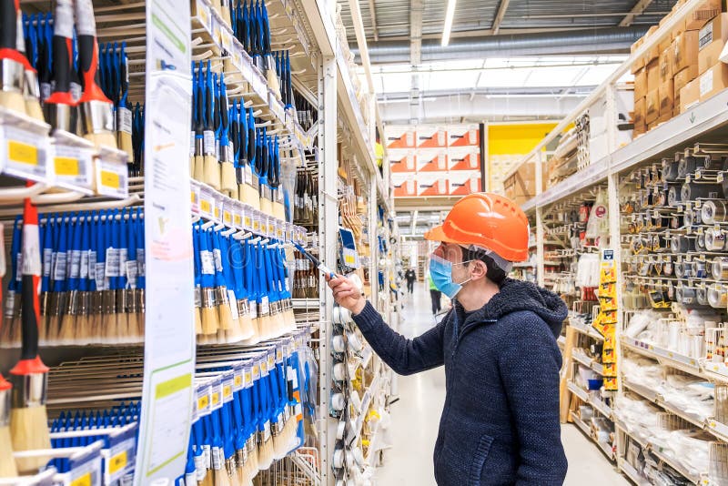 A Man in a Hardware Store. Sells Paint Brushes. Selective Focus Stock ...