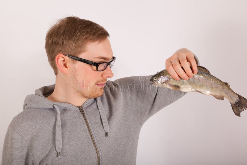 A Man Has a Fish in His Hand Stock Photo - Image of sport, trout: 28923800