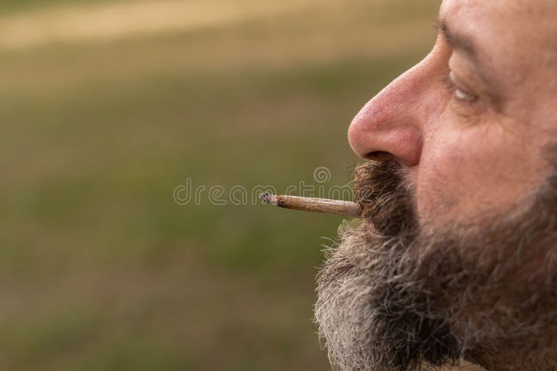 The Man Has His Eye Open and Holds a Cigarette in One Hand Stock Photo ...