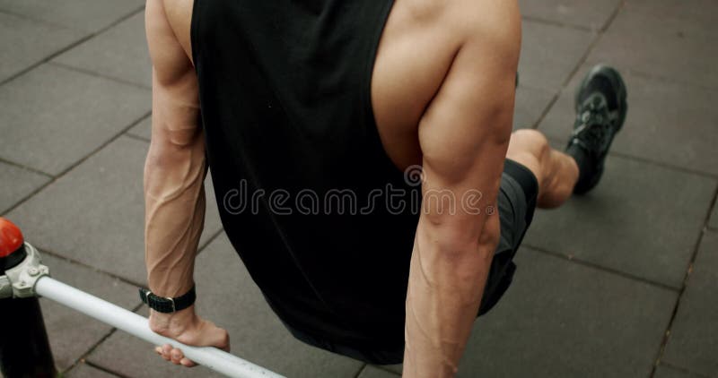 Man Has Workout and Doing Reverse Push Up Exercise on Horizontal Bar ...