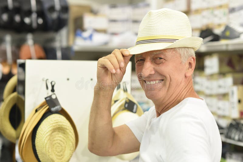 Portrait of a Confident Mature Store Clerk with Arms Crossed in ...