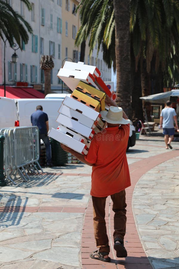 Man with Hat and Sandals Carrying Many Boxes in the City Stock Photo ...