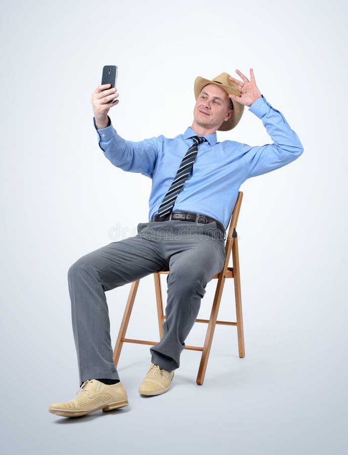Man in Hat and Tie Makes Selfie Sitting on a Chair Stock Image - Image ...
