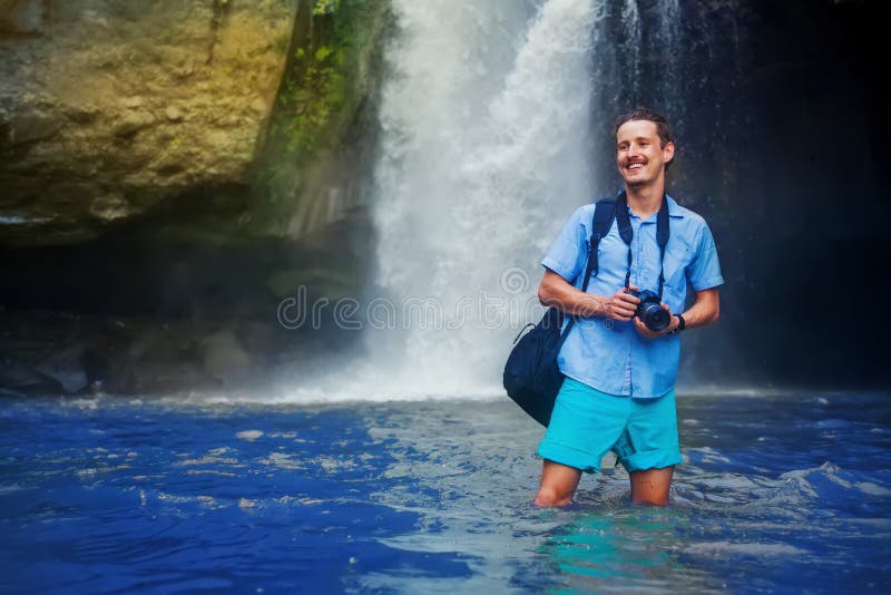 Man Having an Adventurous Tracking with Camera Near the Waterfall Stock ...