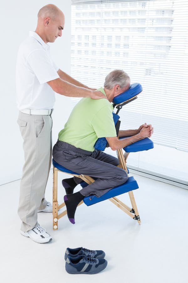 Man having back massage stock photo. Image of examination - 54760270