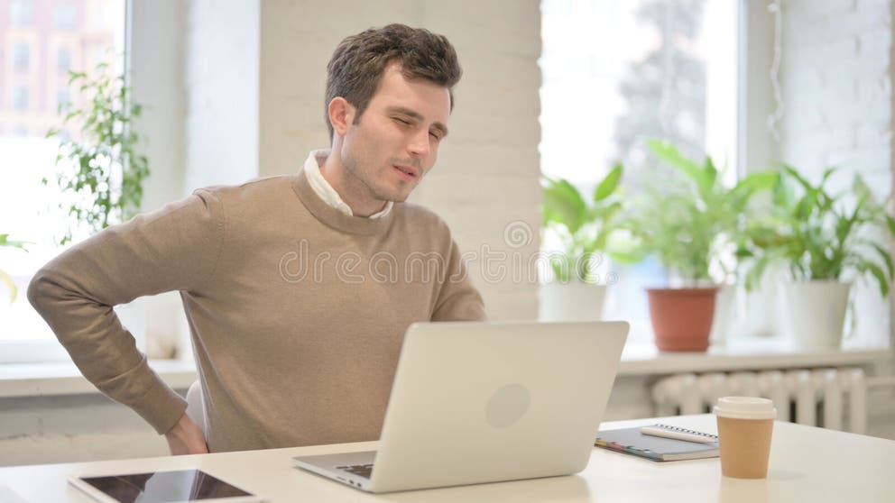 Man Having Back Pain while Using Laptop in Office Stock Image - Image ...