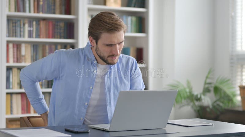 Man Having Back Pain while Using Laptop in Office Stock Photo - Image ...