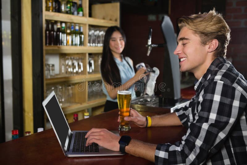Man Having Beer while Using Laptop at Counter Stock Image - Image of ...