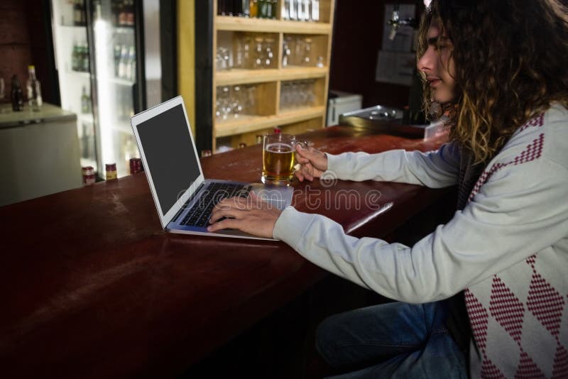 Man Having Beer while Using Laptop at Counter Stock Image - Image of ...
