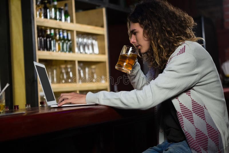 Man Having Beer while Using Laptop at Counter Stock Image - Image of ...