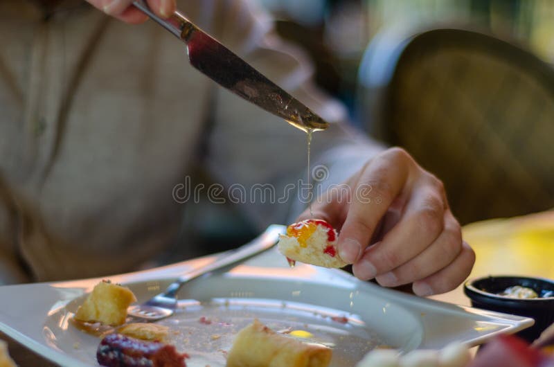 The Man is Eating Breakfast in the Restaurant. Stock Photo - Image of ...