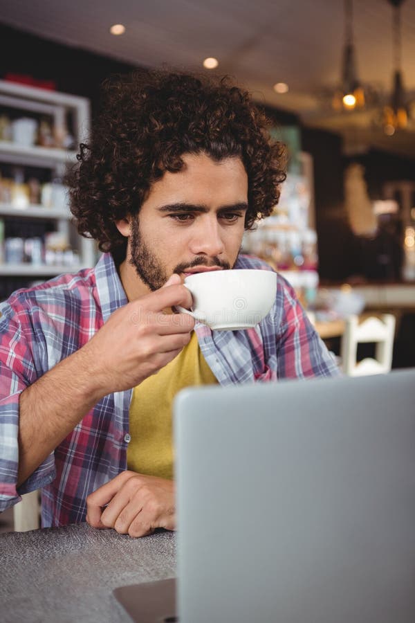 Man Having Coffee while Looking at Laptop Stock Photo - Image of adult ...