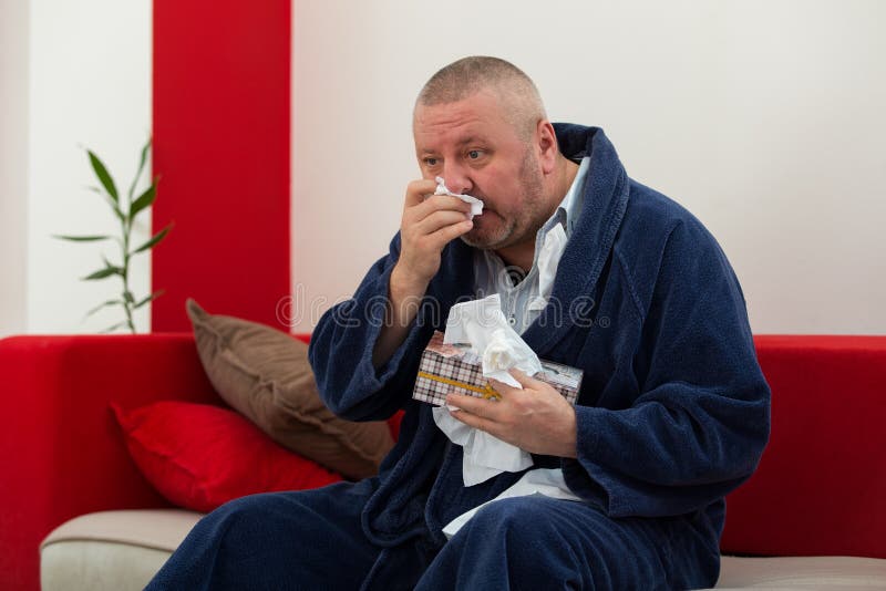 Man Having a Cold Holding Tissue with Box Full of Tissues Stock Photo ...