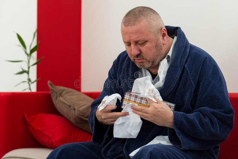 Man Having a Cold Holding Tissue with Box Full of Tissues Stock Photo ...
