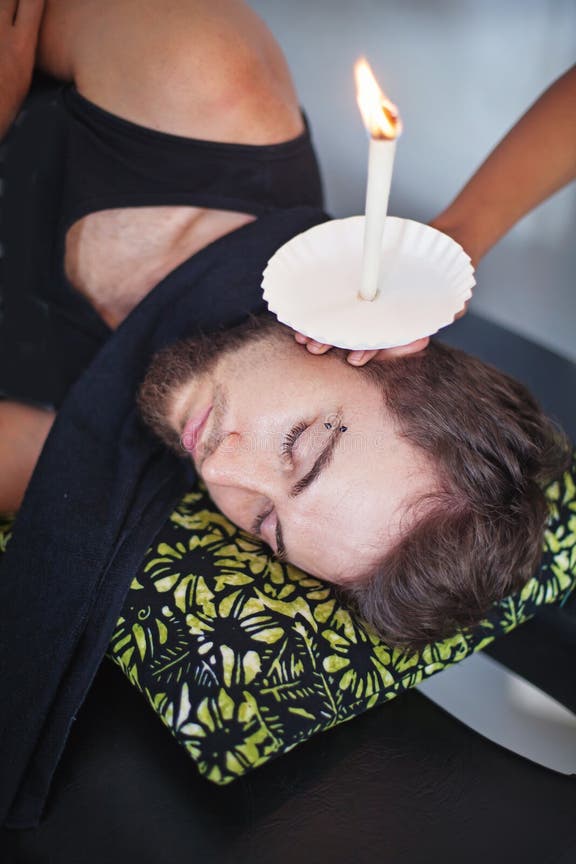 Man Having an Ear Candle Therapy Stock Photo - Image of candle ...